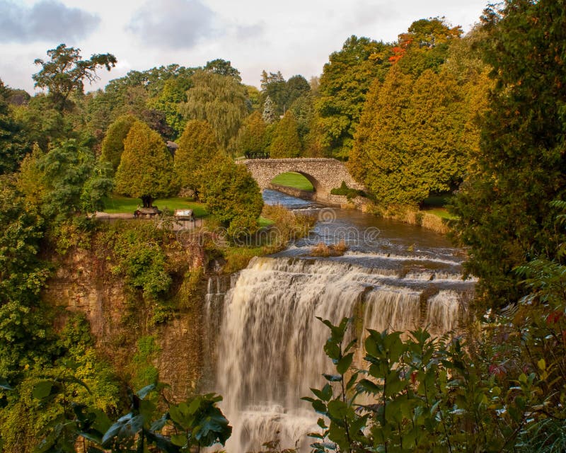 Waterfall with Stone Bridge Stock Image - Image of weathered, waterfall ...