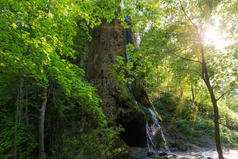 Waterfall on Stream Flowing Along the Rock with Grotto, Backlit Stock ...