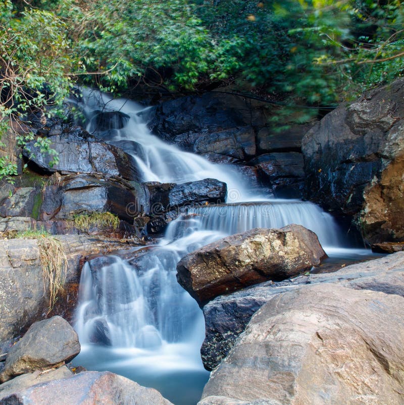 A Waterfall with a Stream of Water Flowing Down it Stock Photo - Image ...