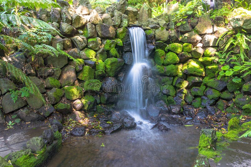Waterfall on sunny day stock photo. Image of tropical - 99192134