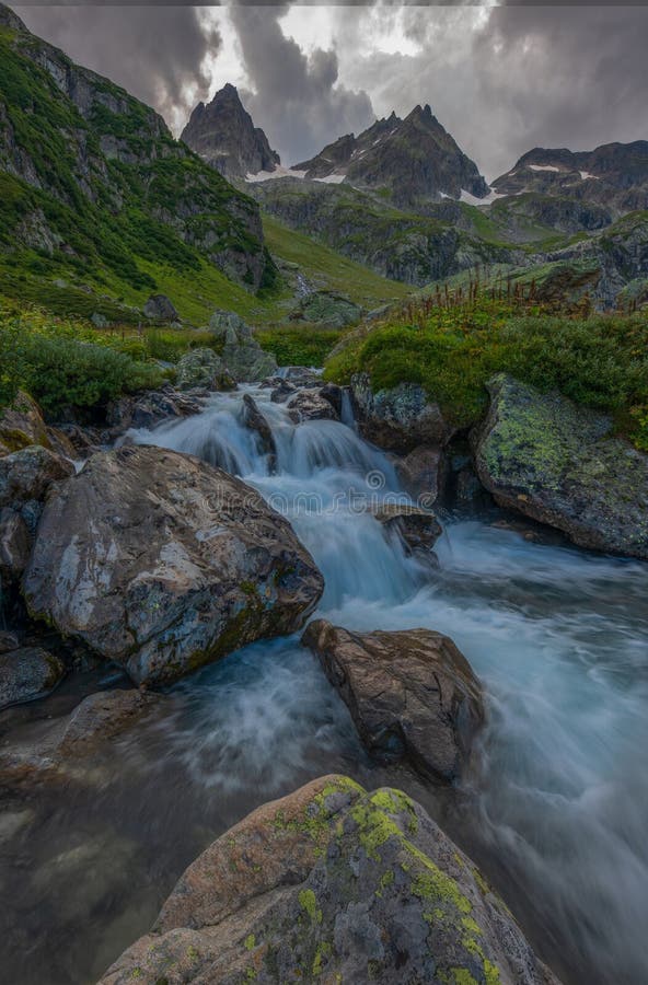 A Waterfall Surrounded by Meadow and Plants Stock Photo - Image of ...