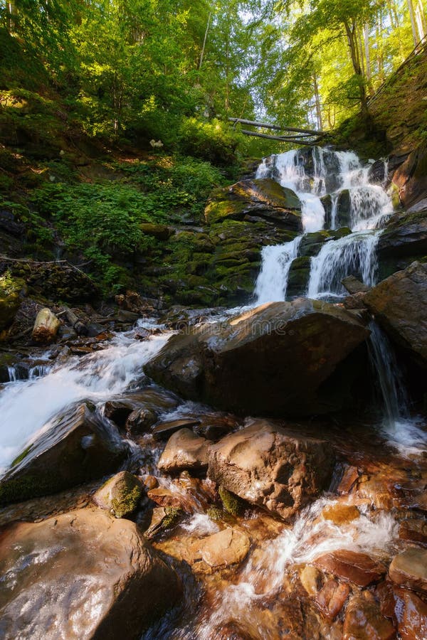 Waterfall among wet rocks stock image. Image of scenic - 271505403