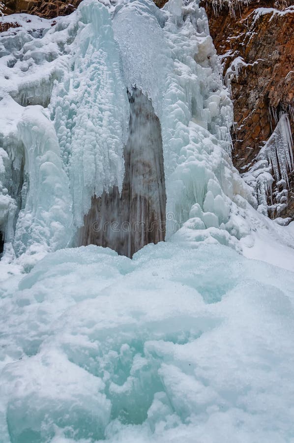 Waterfall in Winter. Mountain River and Snow on the Mountain Slopes ...