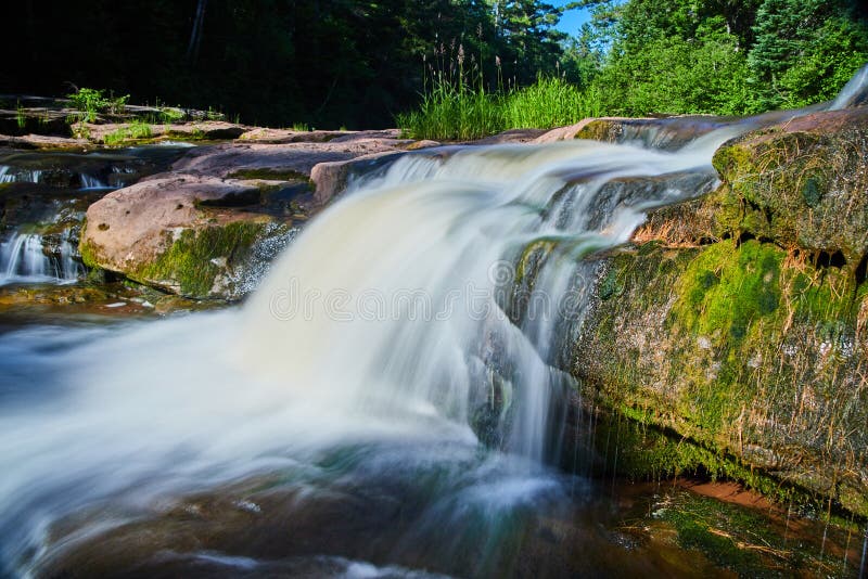 Waterfalls Pouring Over Brown Rocks Covered in Wet Moss Stock Image ...