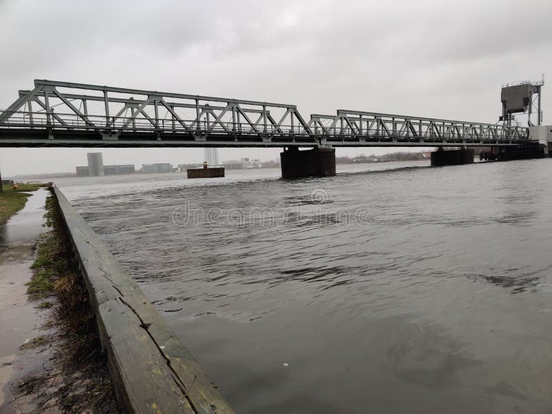 Waterfront with Bridge and Gray Weather Stock Photo - Image of bridge ...