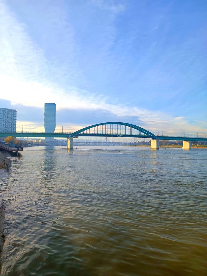 Waterfront View with a Bridge and Green River Stock Image - Image of ...