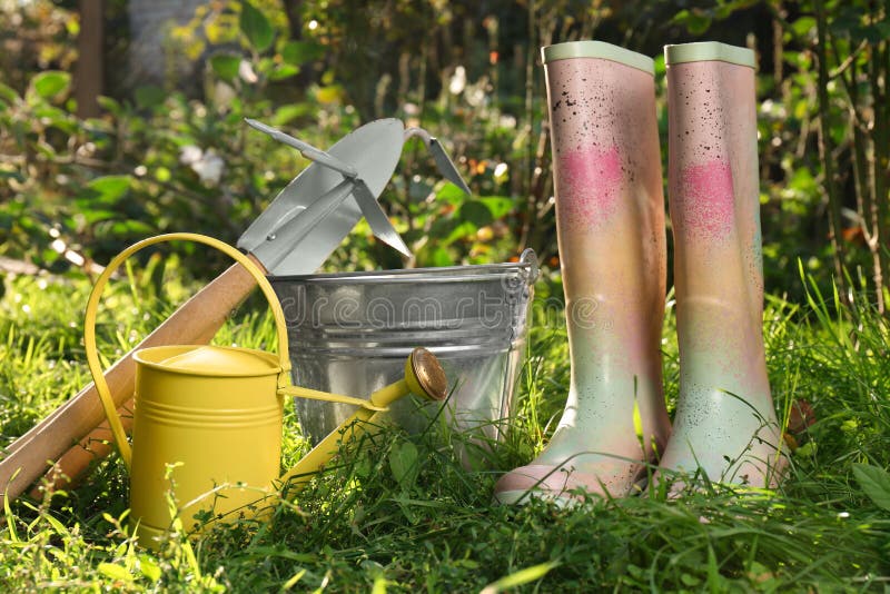 Watering Can, Gardening Tools and Rubber Boots on Green Grass Outdoors ...