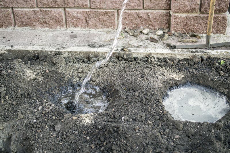 Watering of the earth stock image. Image of construction - 76521575