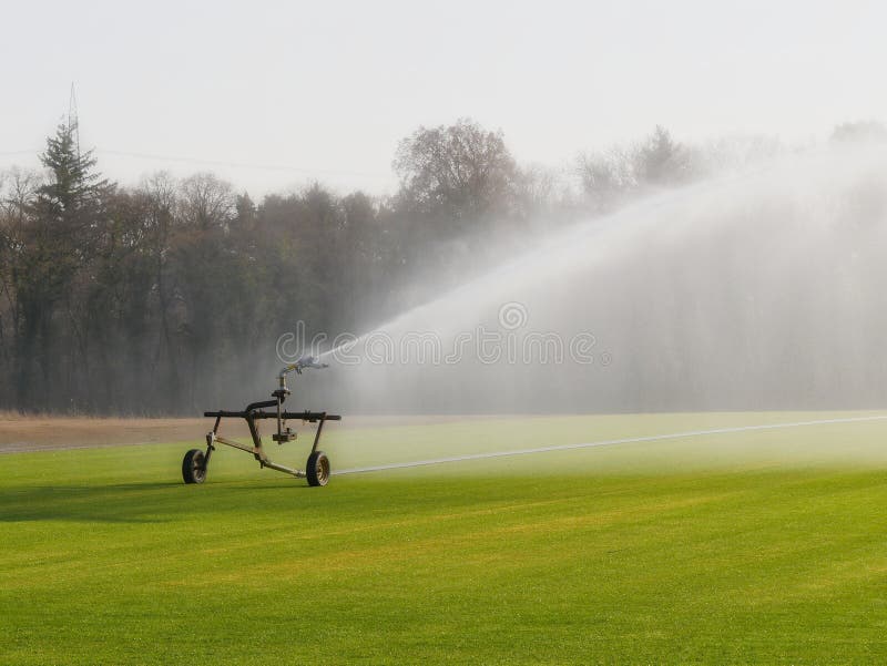 Watering field stock photo. Image of plain, wind, sprinkler - 244086400