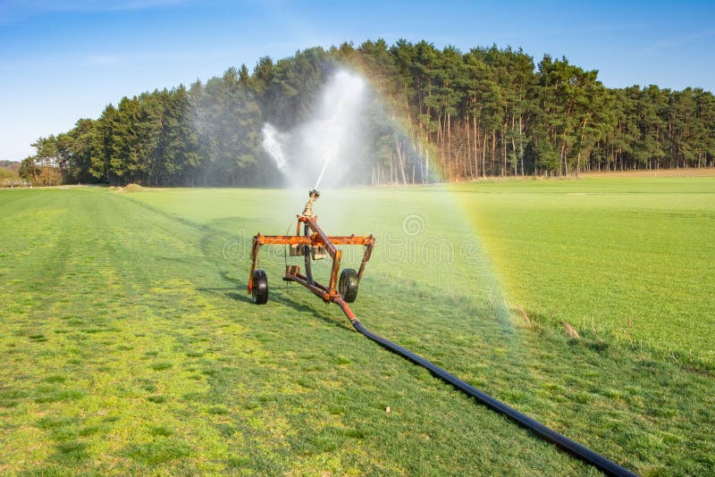 Watering a field stock image. Image of country, splashing - 116410145