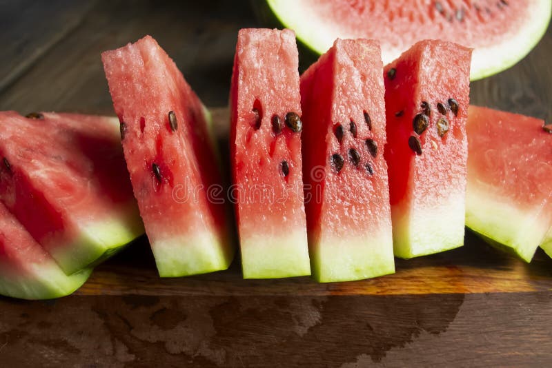 Watermelon Cut into Small Triangles on a Wooden Board. Sweet Slices of ...