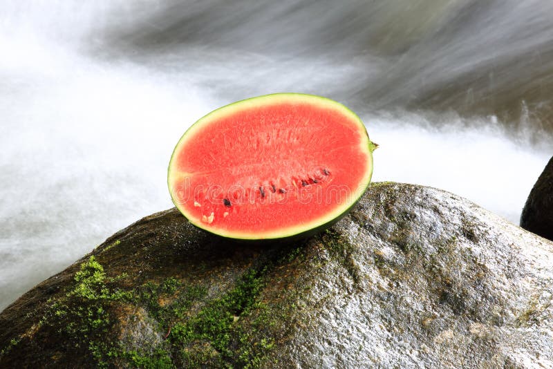 Watermelonon on the Rocks in the River Stock Photo - Image of slice ...