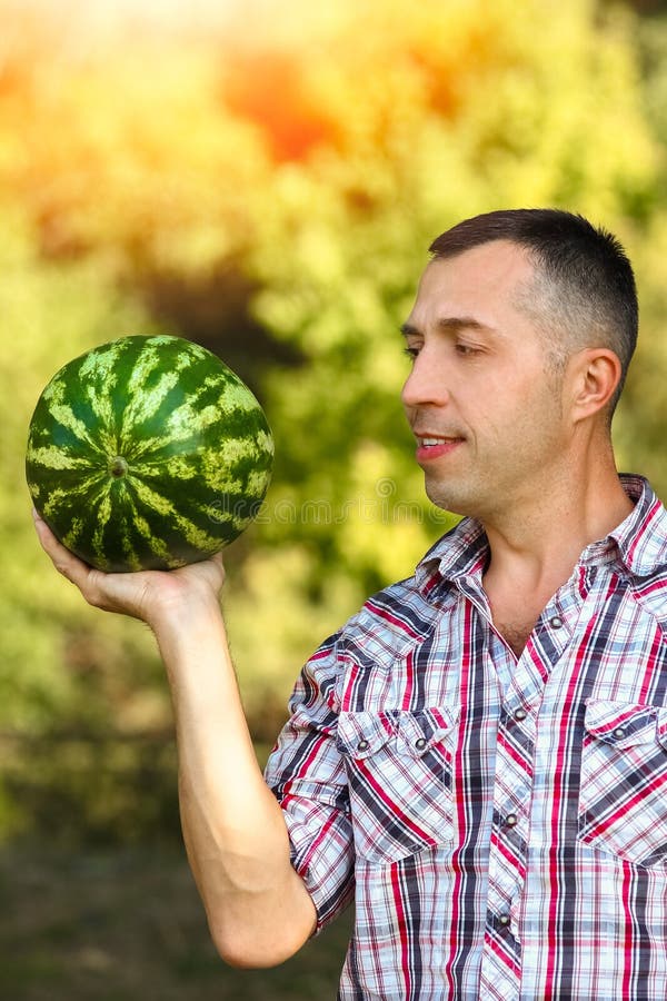 Watermelon in the Hands of a Guy on Nature in the Park Stock Photo ...
