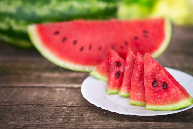 Watermelons cuts on plate stock image. Image of sliced - 103936435