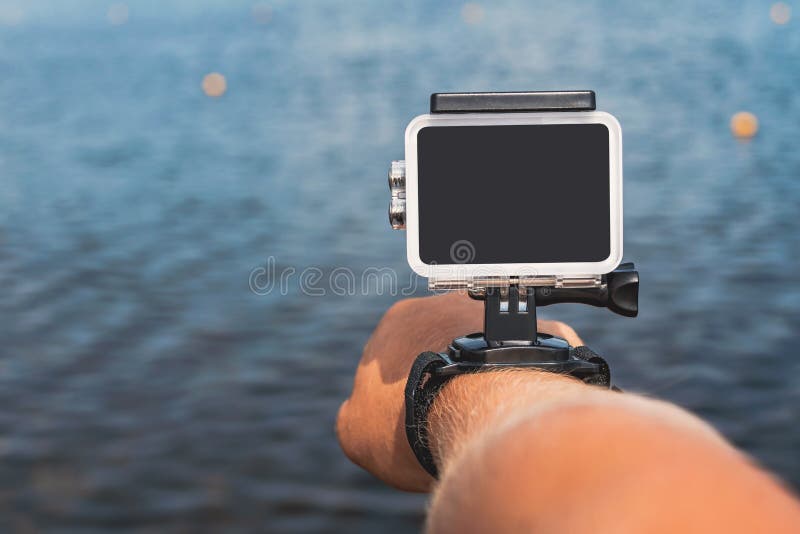 Waterproof Action Camera with Mounts on a Man`s Hand. Against the ...