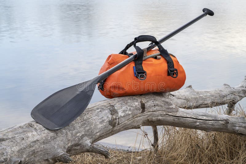 Waterproof Duffel and Stand Up Paddle on a Lake Shore Stock Photo ...