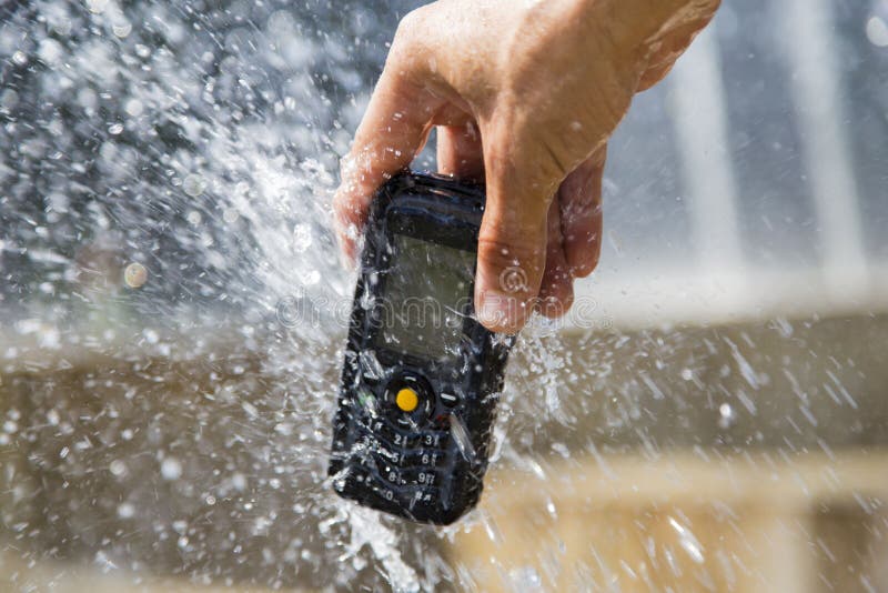 Testing a Rugged Mobile Phone Stock Photo - Image of spray, holiday ...
