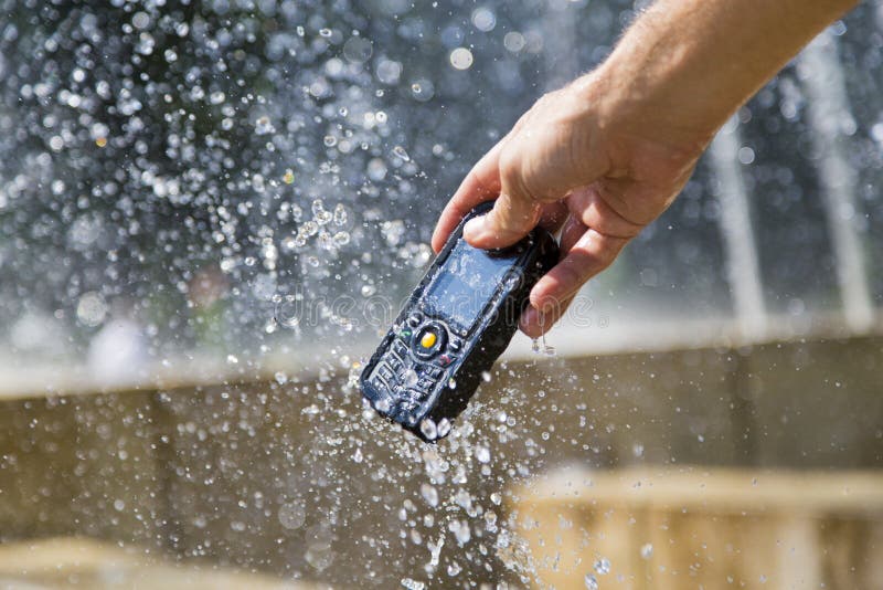 Testing a Rugged Mobile Phone Stock Photo - Image of spray, holiday ...