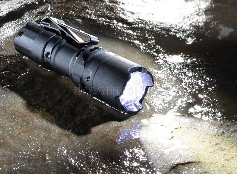 Waterproof Tactical Flashlight on a Rock Stock Photo - Image of polymer ...