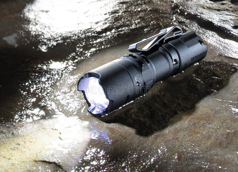 Waterproof Tactical Flashlight on a Rock Stock Image - Image of beige ...