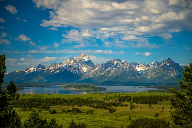 Waters of Jackson Lake Glow Below Grand Teton Mountains Stock Photo ...