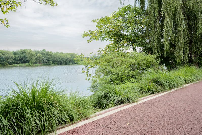 Waterside Red-painted Foot Path in Cloudy Summer Stock Image - Image of ...