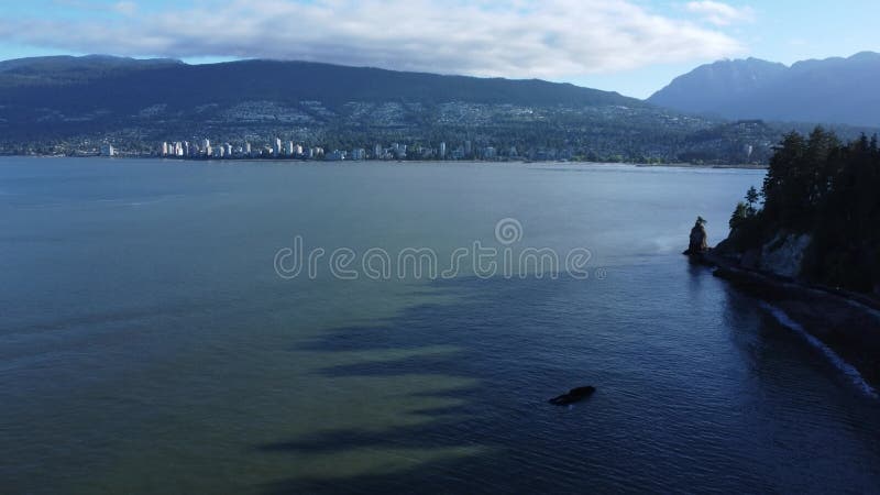 Waterside View of the Coastal City Buildings before the Mountains Under ...
