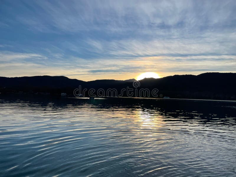 Waterside View of the Silhouettes of Mountains Under the Blue Sunset ...
