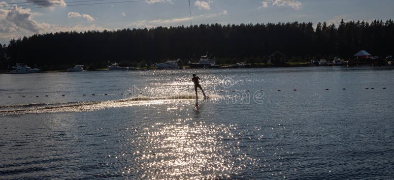 Waterskier Silhouette Moving Fast in Splashes of Water at Sunset Stock ...