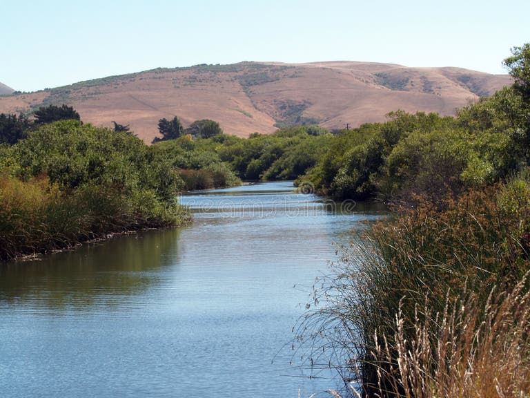 Waterway slough with hills stock image. Image of blue - 6031769