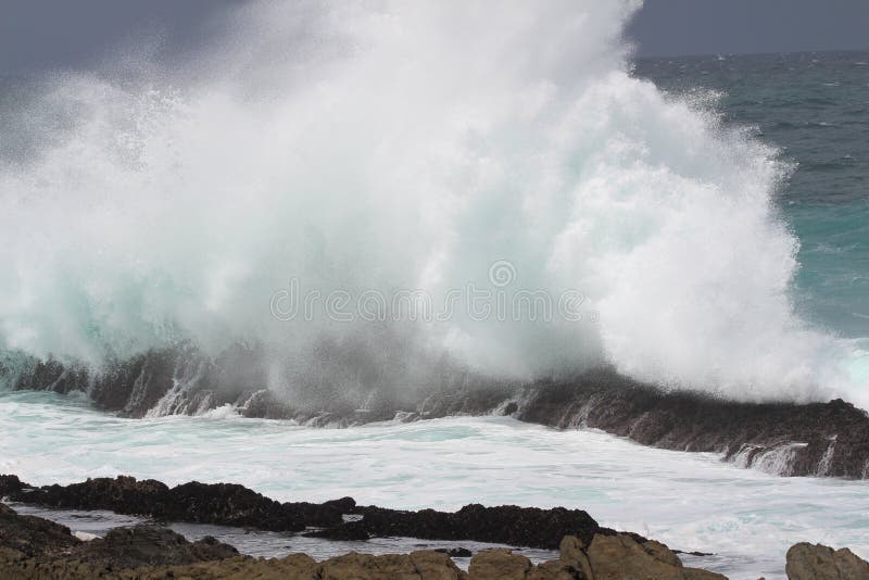 Wave against the rocks stock photo. Image of colors, away - 94927732