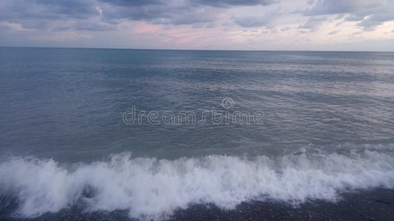 The Wave in the Back Sea Runs Onto the Coast. Stock Image - Image of ...