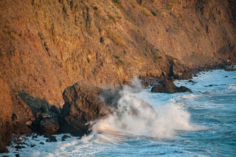 A Wave Breaking Across a Rocky Shore Stock Photo - Image of foam, ocean ...