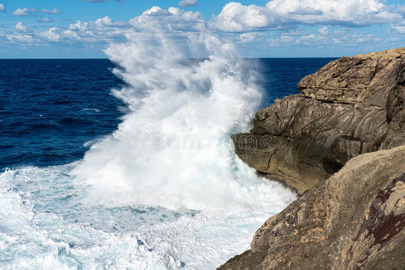 Wave breaking on a cliff stock image. Image of sunny - 171220239