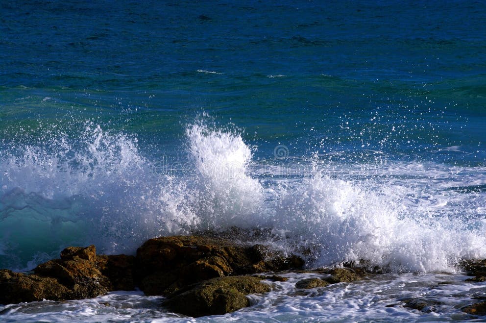 Wave breaking over a rock stock image. Image of pacific - 50067537
