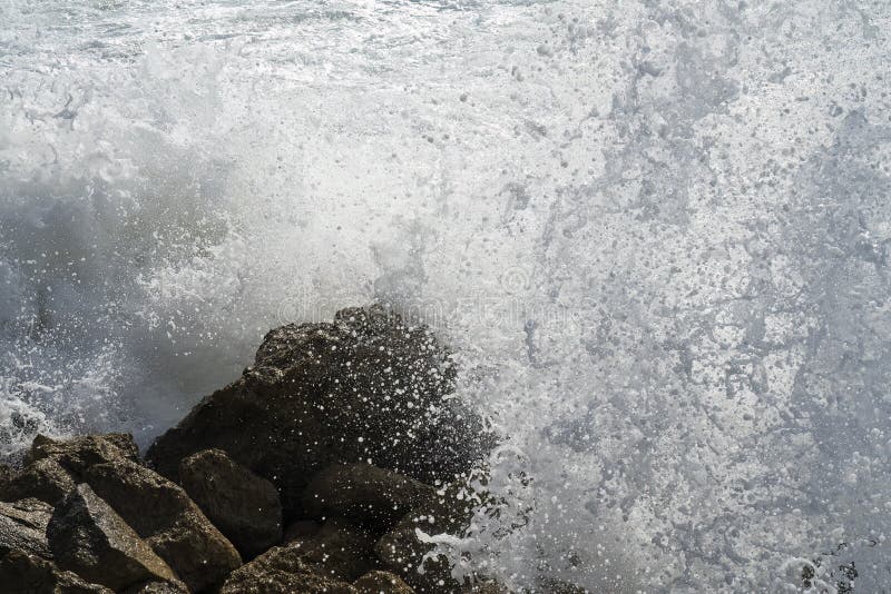 A Wave Breaking on Rocks stock image. Image of nature - 258494011
