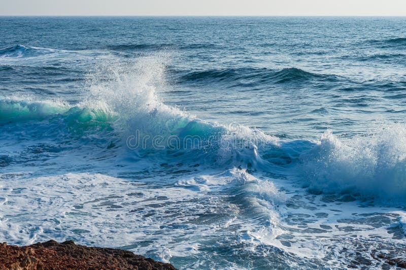 Wave Breaking on a Rugged Cliffside Stock Photo - Image of energy, foam ...