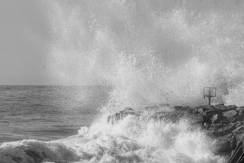 Wave breaking in the rocks stock image. Image of wave - 138062369