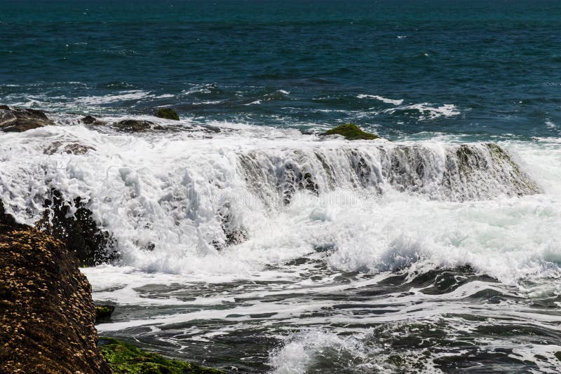 Wave Cascading Over Rocks at Low Tide; Bali, Indonesia. Stock Photo ...