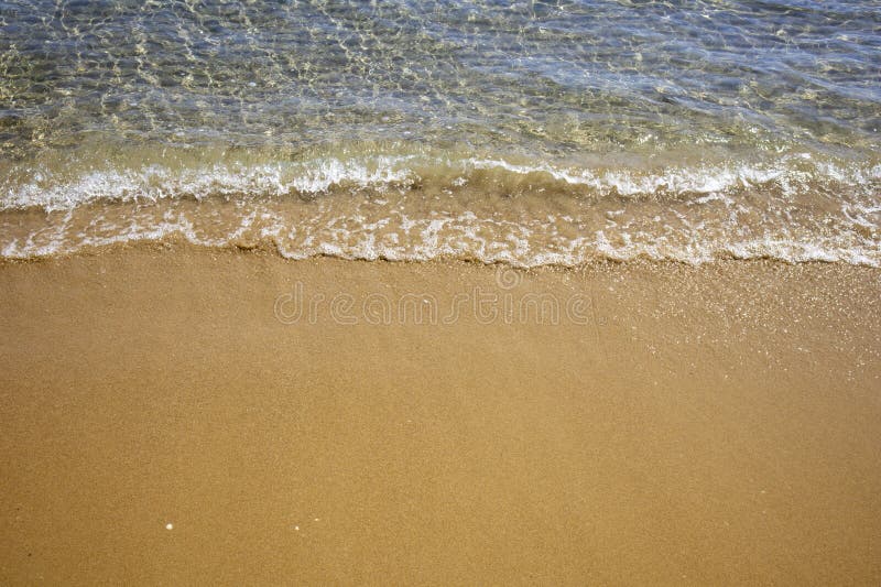 A Wave of Clear Transparent Water on the Beach Close-up of Sand. Stock ...