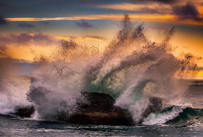 Powerful Wave Crashes Against a Coastal Rock Causing a Huge Splash into ...
