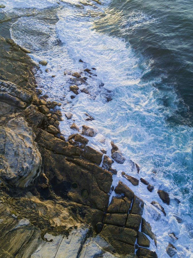 Wave crashing into rocks stock image. Image of outdoors - 92328391