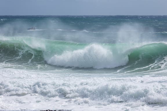 A Large Wave Breaks and Throws Up Wind Driven Spray in Rough, Pre ...