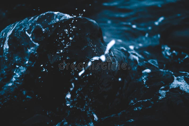 Water Hitting Rocks and Small Drops Splash into the Camera Stock Image ...