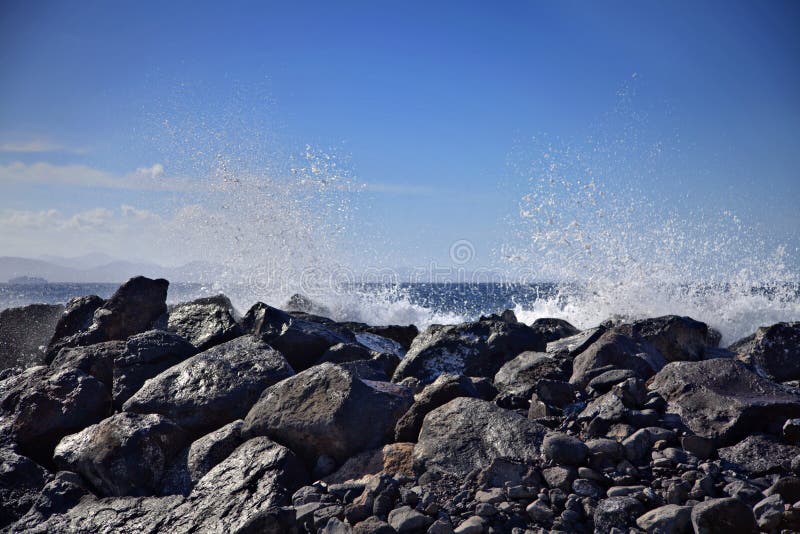Wave Hitting Rocks with Blue Sky Stock Image - Image of white, stones ...