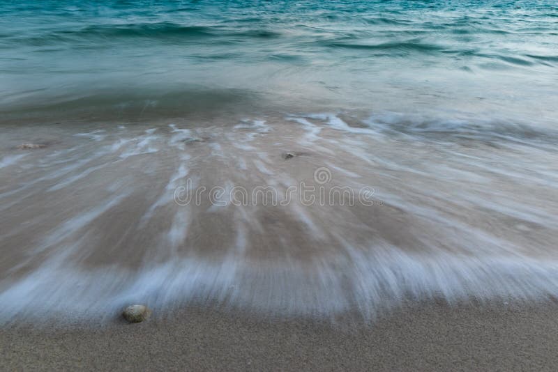 Wave motion on the beach stock image. Image of ocean - 238102637