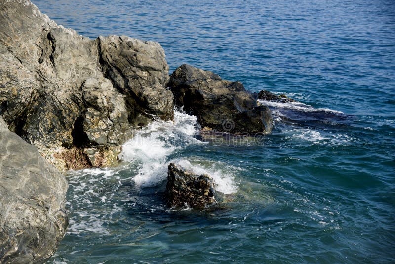 Wave and rocks by the sea stock image. Image of nature - 141075889