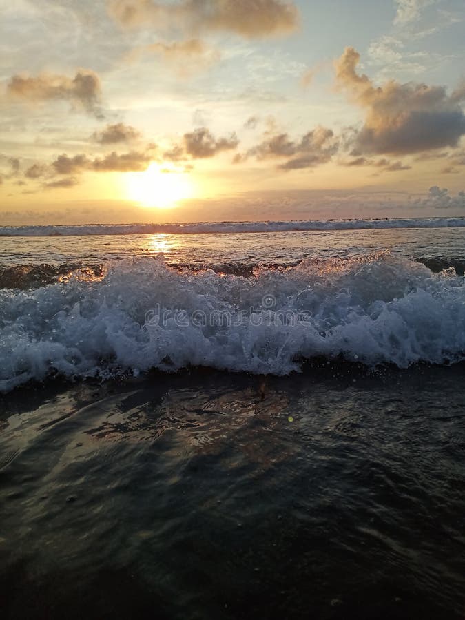 The Wave Rolling Under the Sunset Stock Photo - Image of wave, sunset ...
