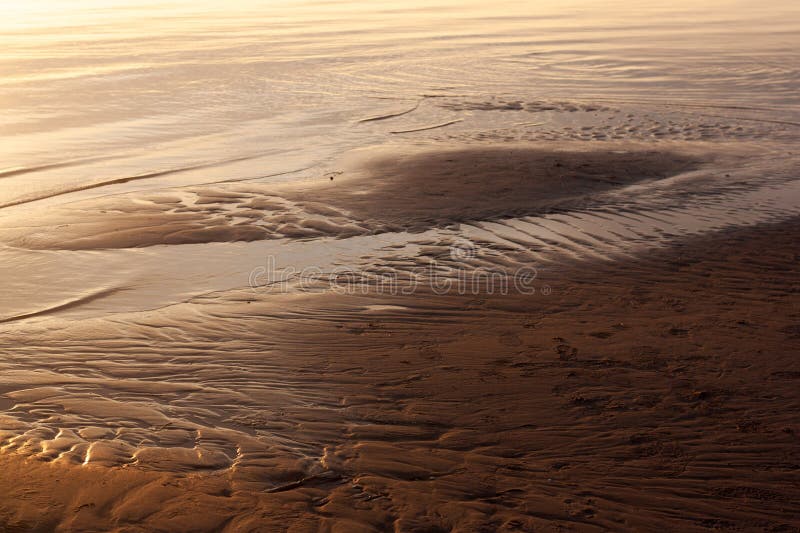 A Wave in the Sand is Creating a Pattern of Water Stock Image - Image ...