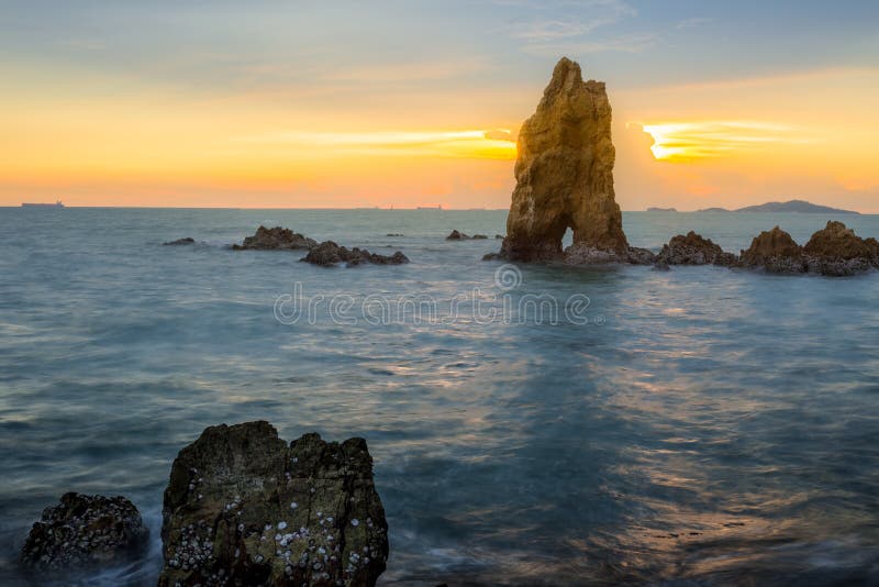 Wave sea sunset rock tower stock photo. Image of seascape - 63116334